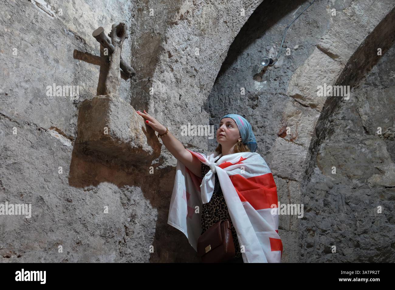 JERUSALEM - APRIL 18: An Orthodox Christian prays inside the crypt of ...