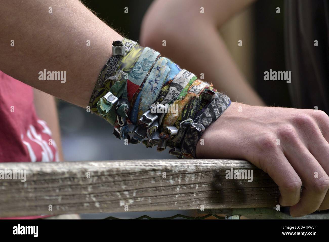 A collection of bracelets on one arm Stock Photo - Alamy