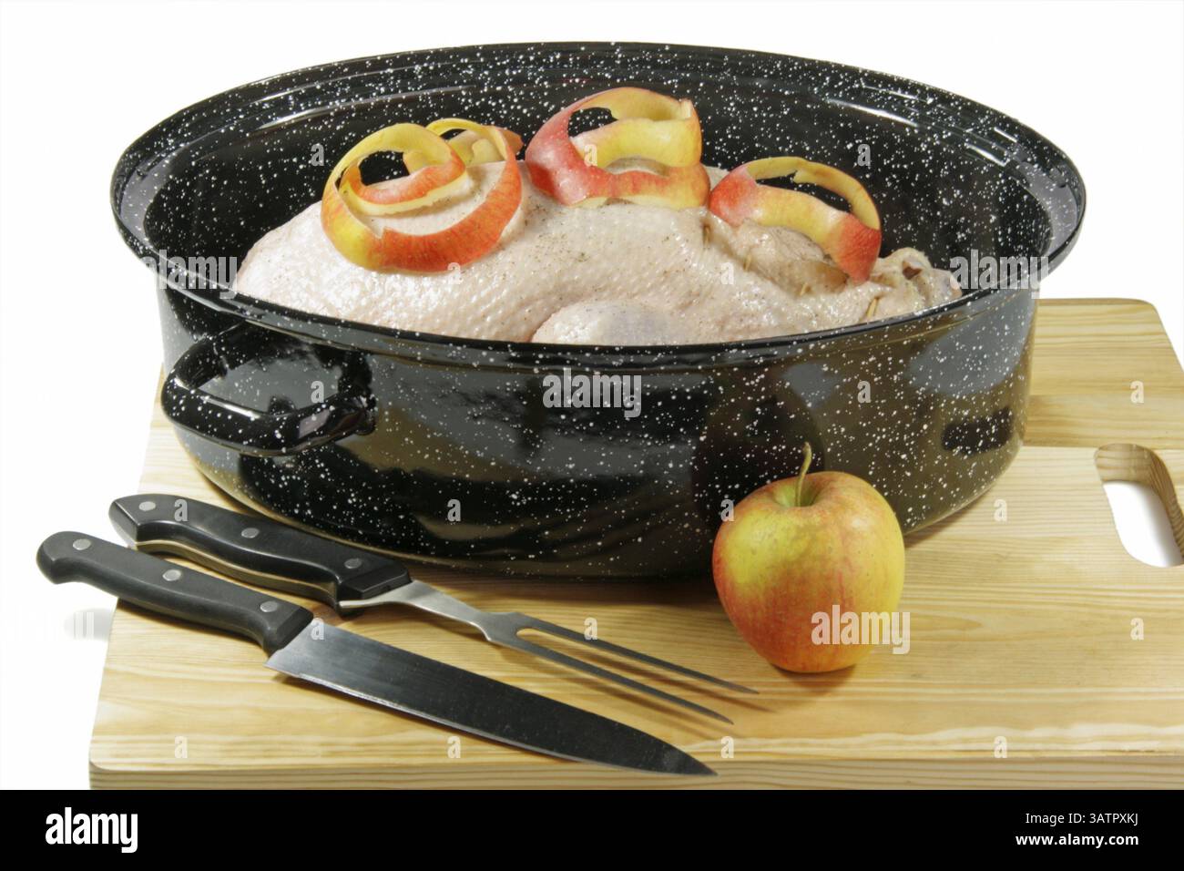 Raw goose stuffed with apples in a goose roaster Stock Photo - Alamy