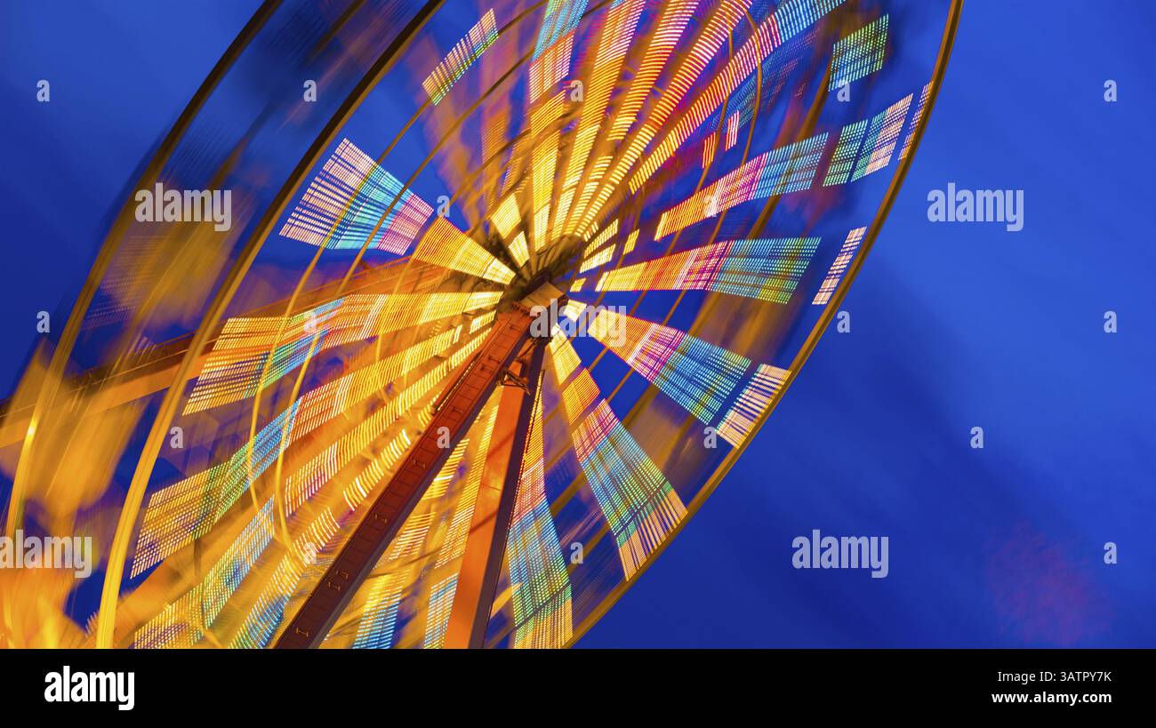 Turning illuminated ferris wheel shot at long exposure Stock Photo - Alamy