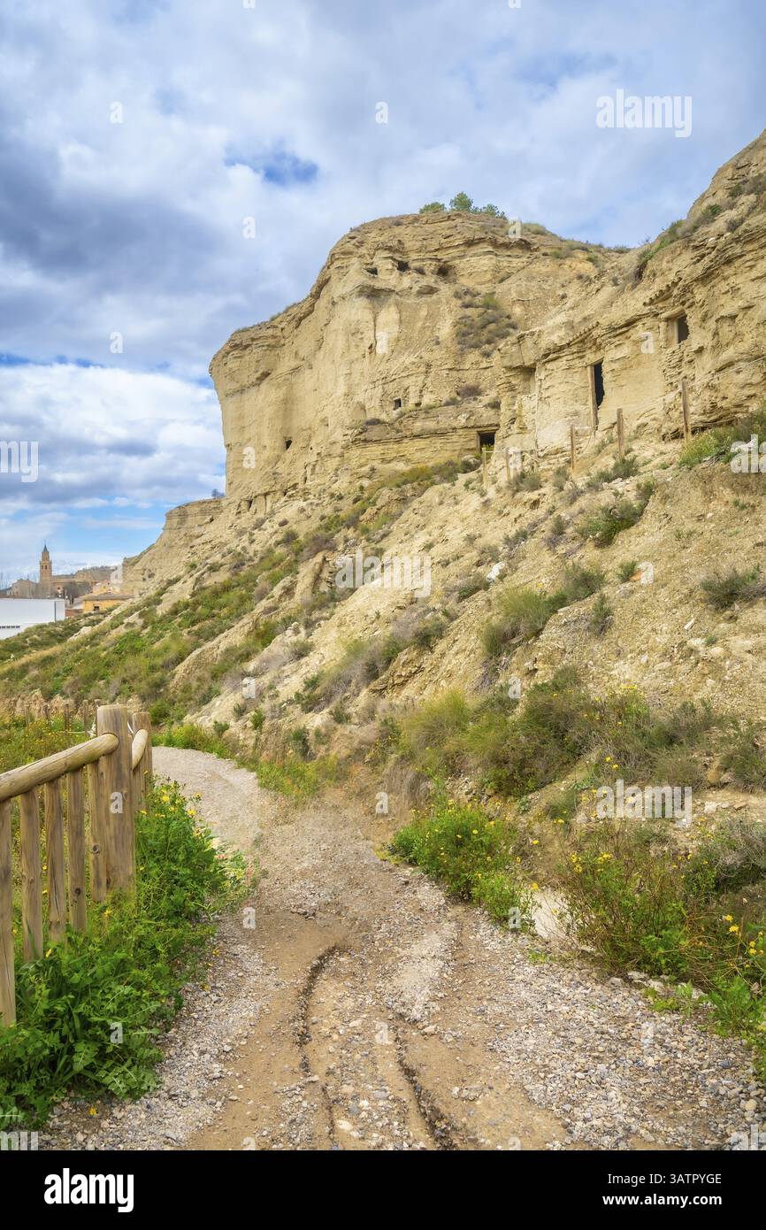 Pathway leading to the historical arguedas caves nestled in the rocky ...