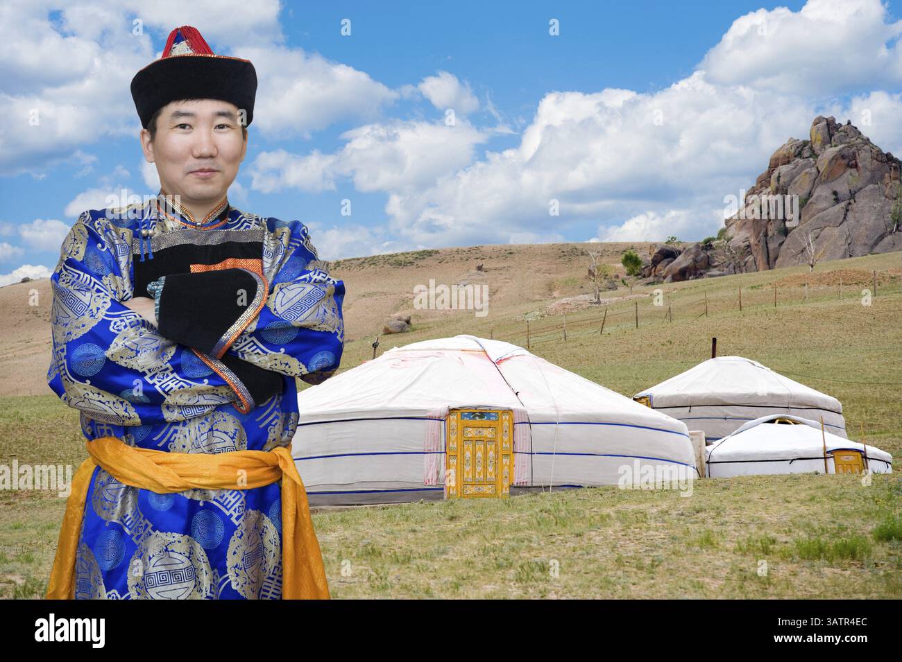 A Buryat (Mongolian) man against some jurts camping in summer steppe ...