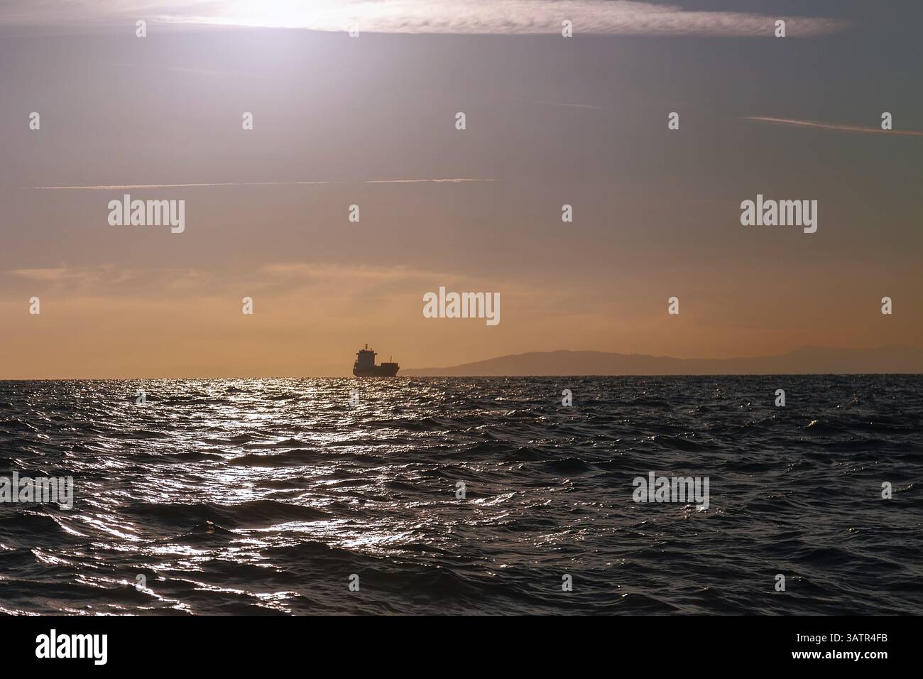 Cargo ship sailing sunset hi-res stock photography and images - Alamy