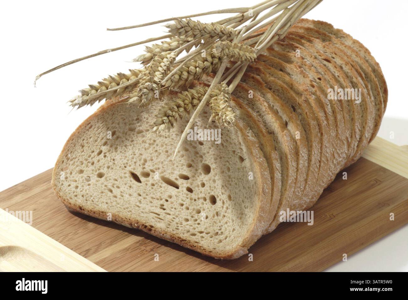 Sliced mixed wheat bread with ears of grain Stock Photo - Alamy