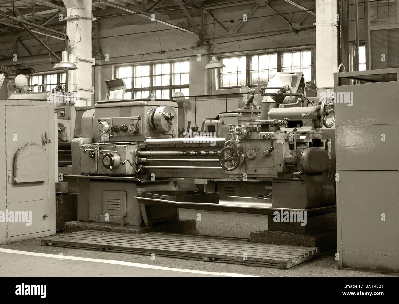 A vintage turning machine at a factory floor Stock Photo - Alamy