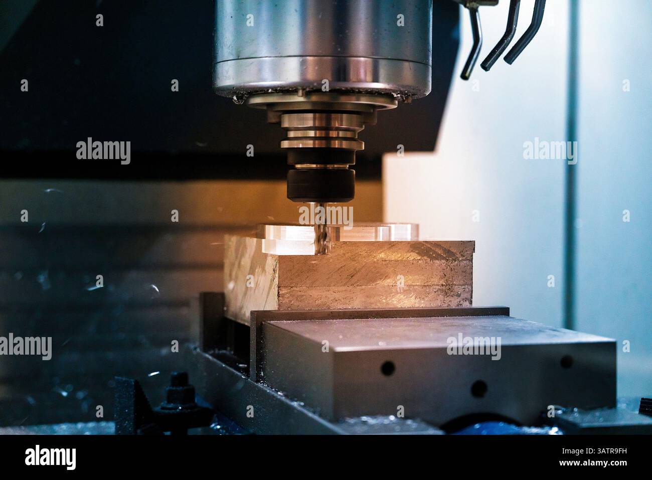 The CNC milling machine drilling at the metal part by flat drill tools ...