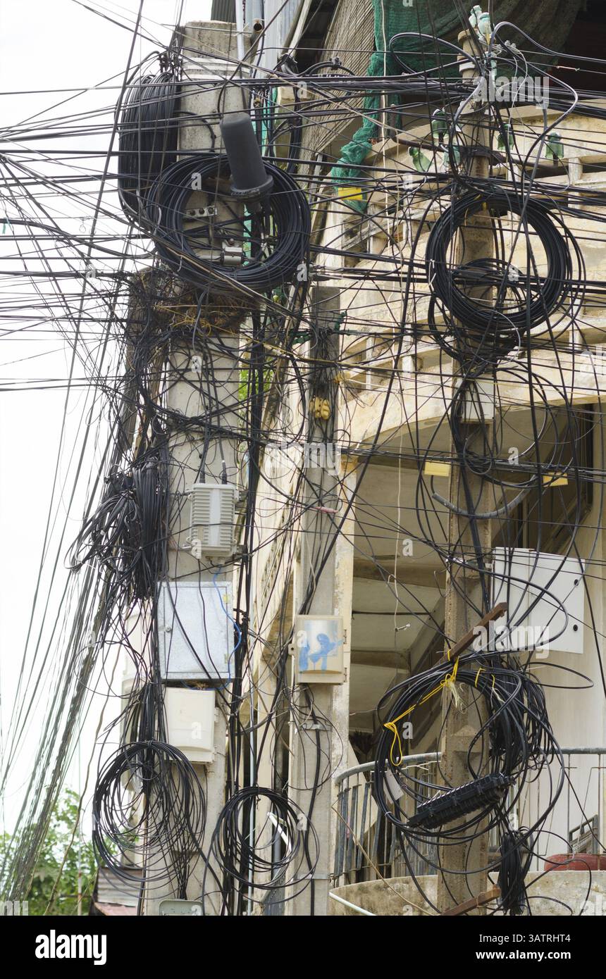 Tangled wires on electric poles in Cambodia Stock Photo - Alamy