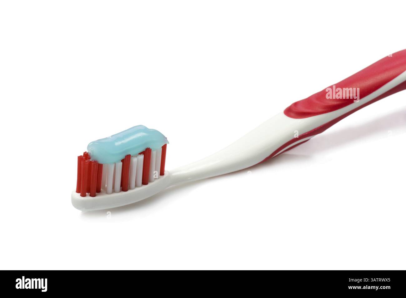 Red toothbrush with toothpaste - cropped on white Stock Photo - Alamy