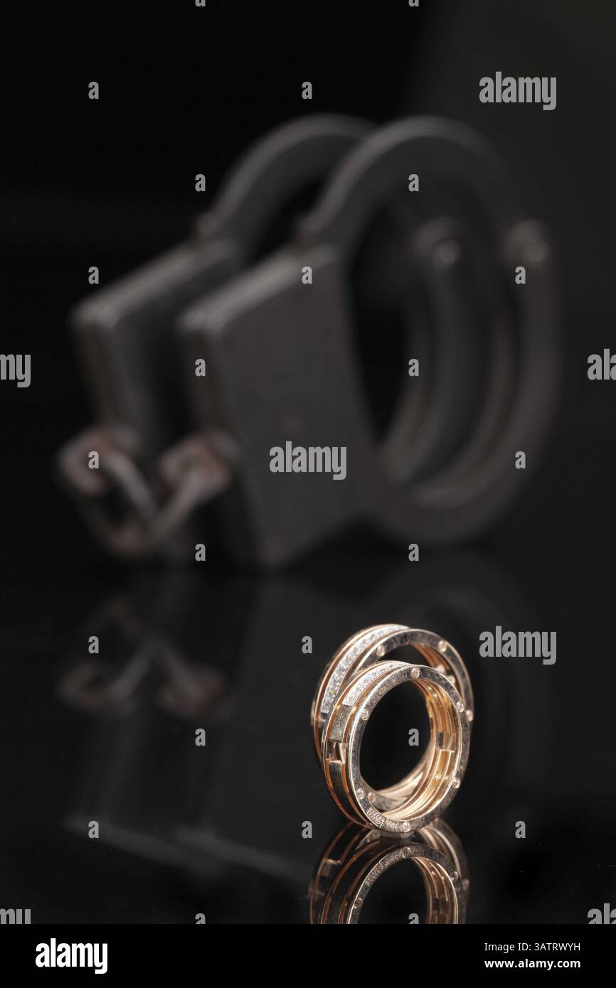 Engagement rings and handcuffs on a glass studio background Stock Photo ...