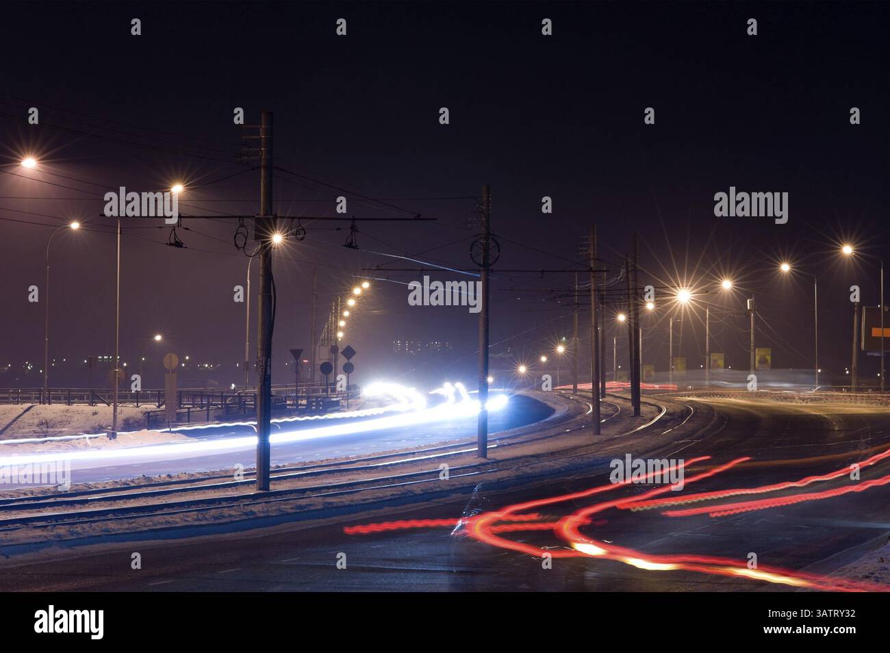 Night city traffic lights in motion under street lamps Stock Photo - Alamy