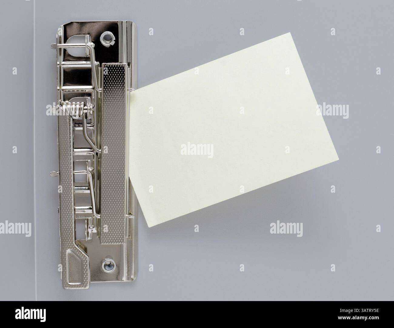 A small blank sheet of note paper in a clip file Stock Photo - Alamy