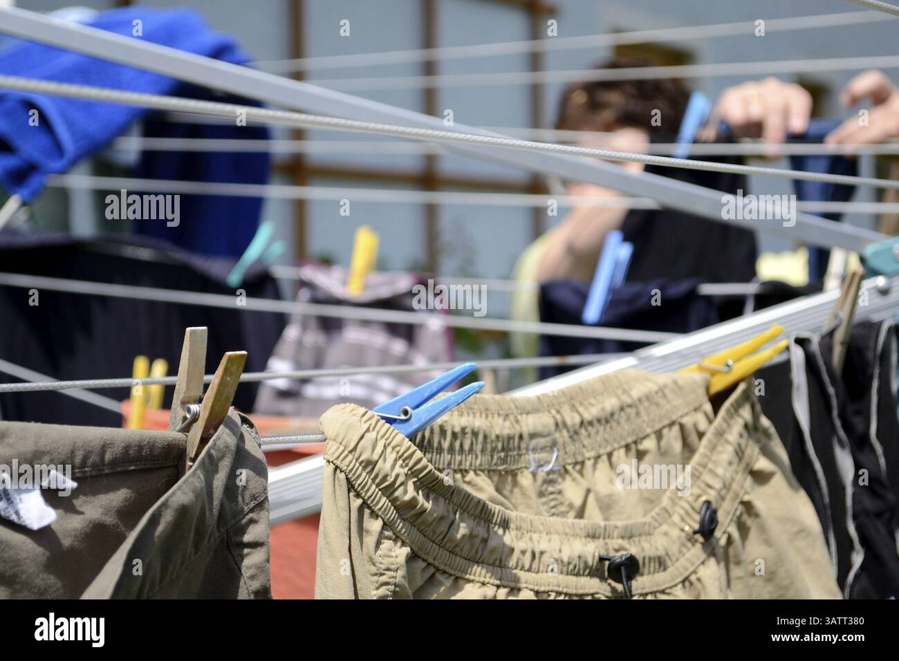 Clothes hung up to dry on the rotary dryer Stock Photo - Alamy
