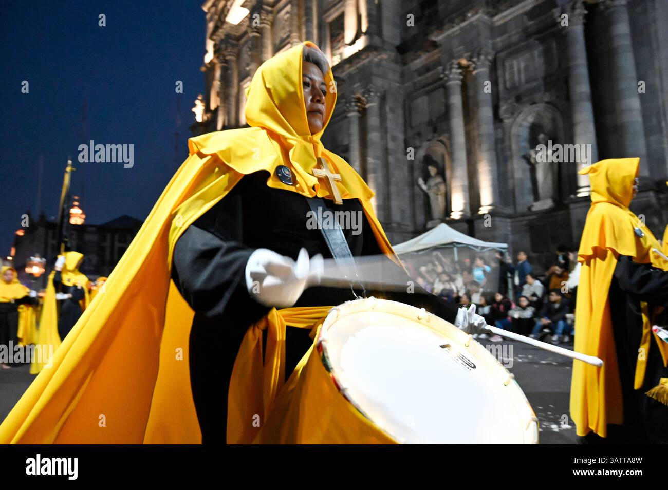 A Hooded penitent carry a torche and take a vow of silence as taking ...