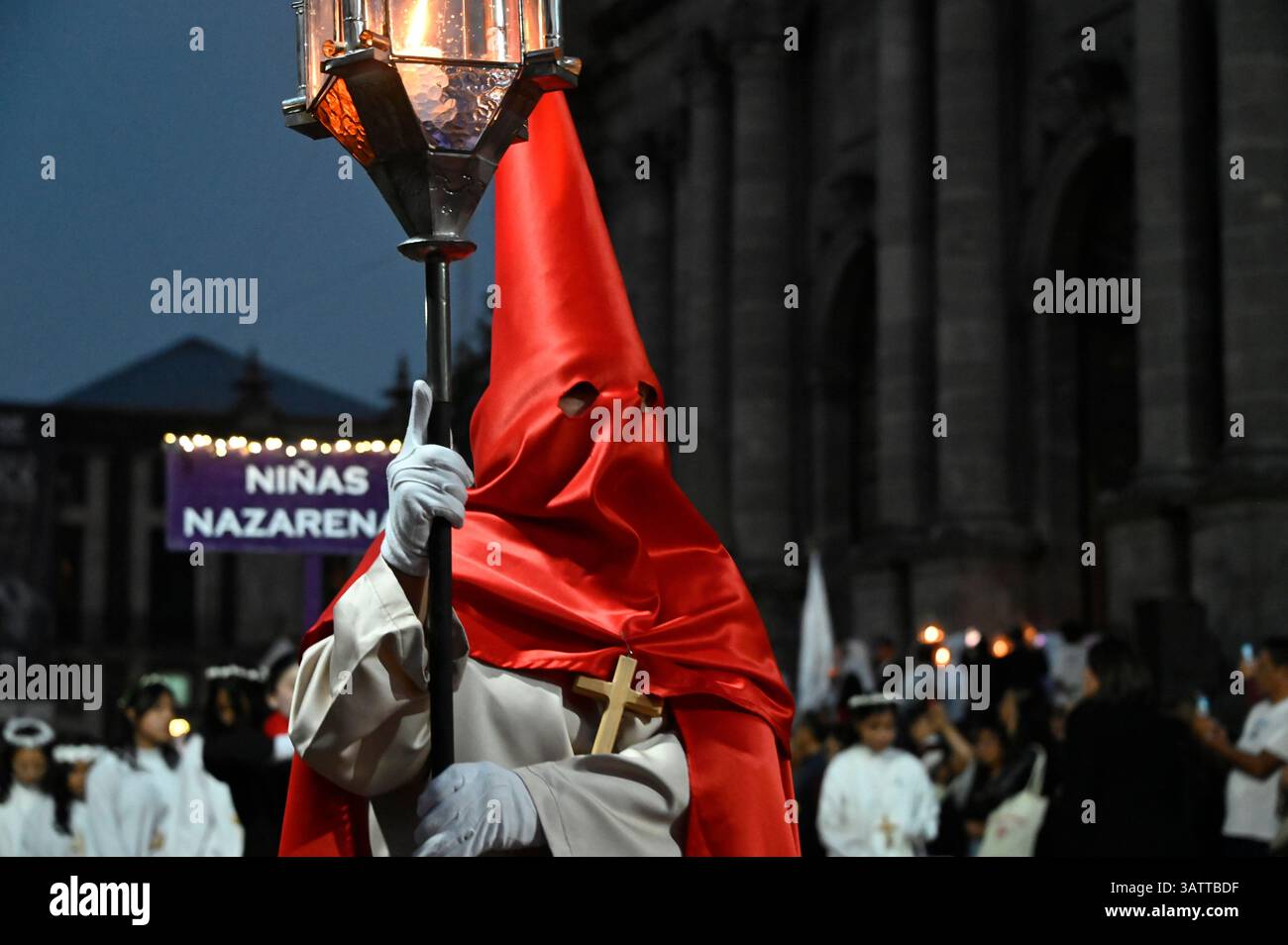 Toluca, Mexico. 18th Apr, 2025. A Hooded penitent carry a torche and ...