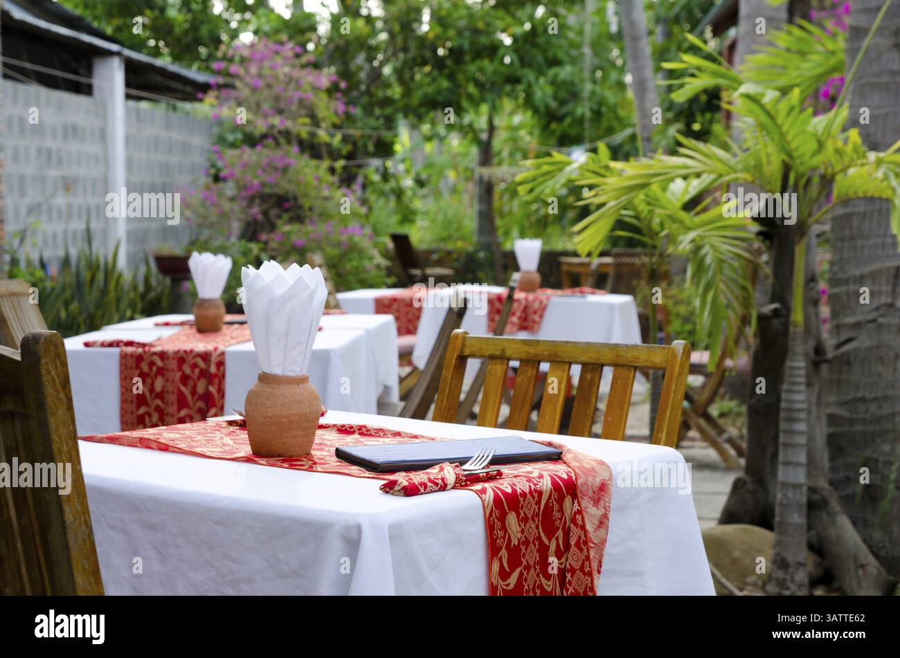 Outdoor restaurant in Vietnam - empty served tables Stock Photo - Alamy