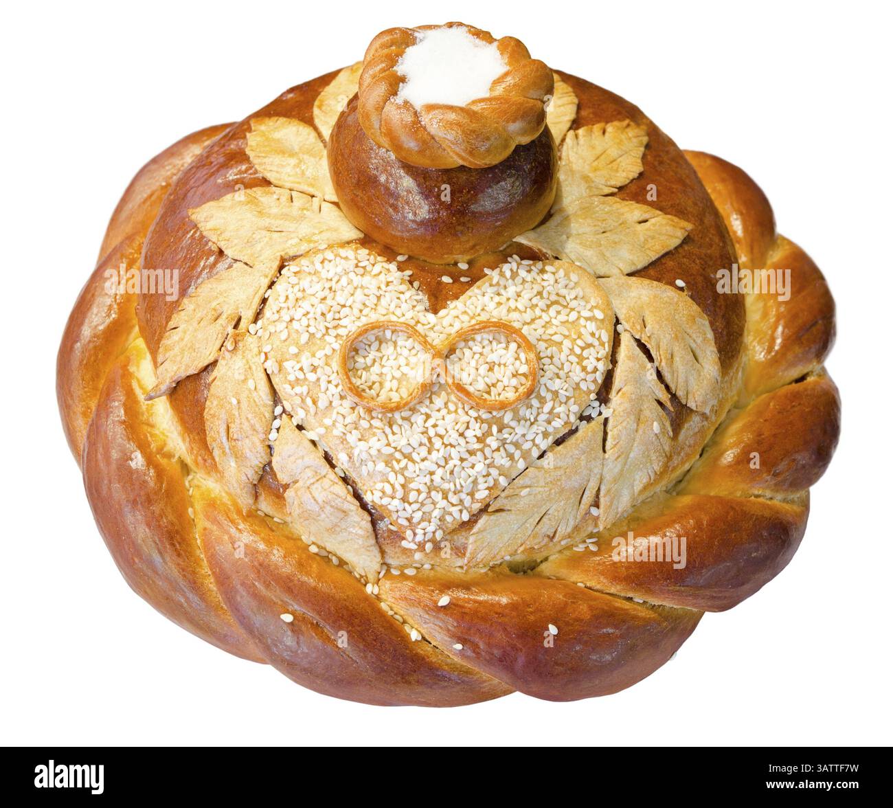 A fresh round loaf of wedding bread, rings on a heart, salt on top ...