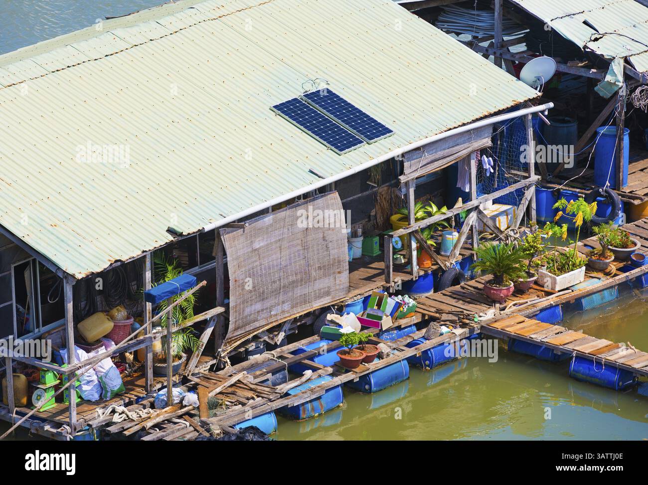 Floating dwelling house with solar batteries at fish breeding farm ...