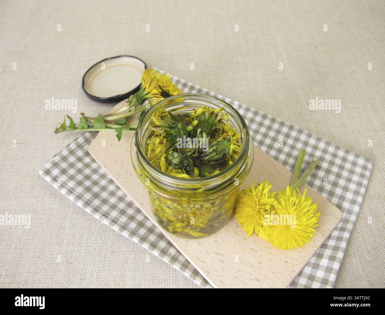 Dandelion flower decoction with dandelion flowers in a jar Stock Photo ...
