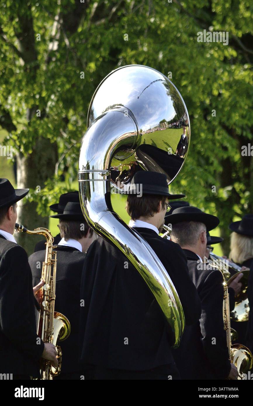 People in traditional traditional costume play saxophone and sousaphone ...