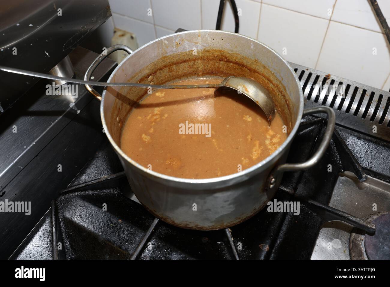 Chef cooking curry in a pot in a kitchen in Hampshire, UK Stock Photo ...