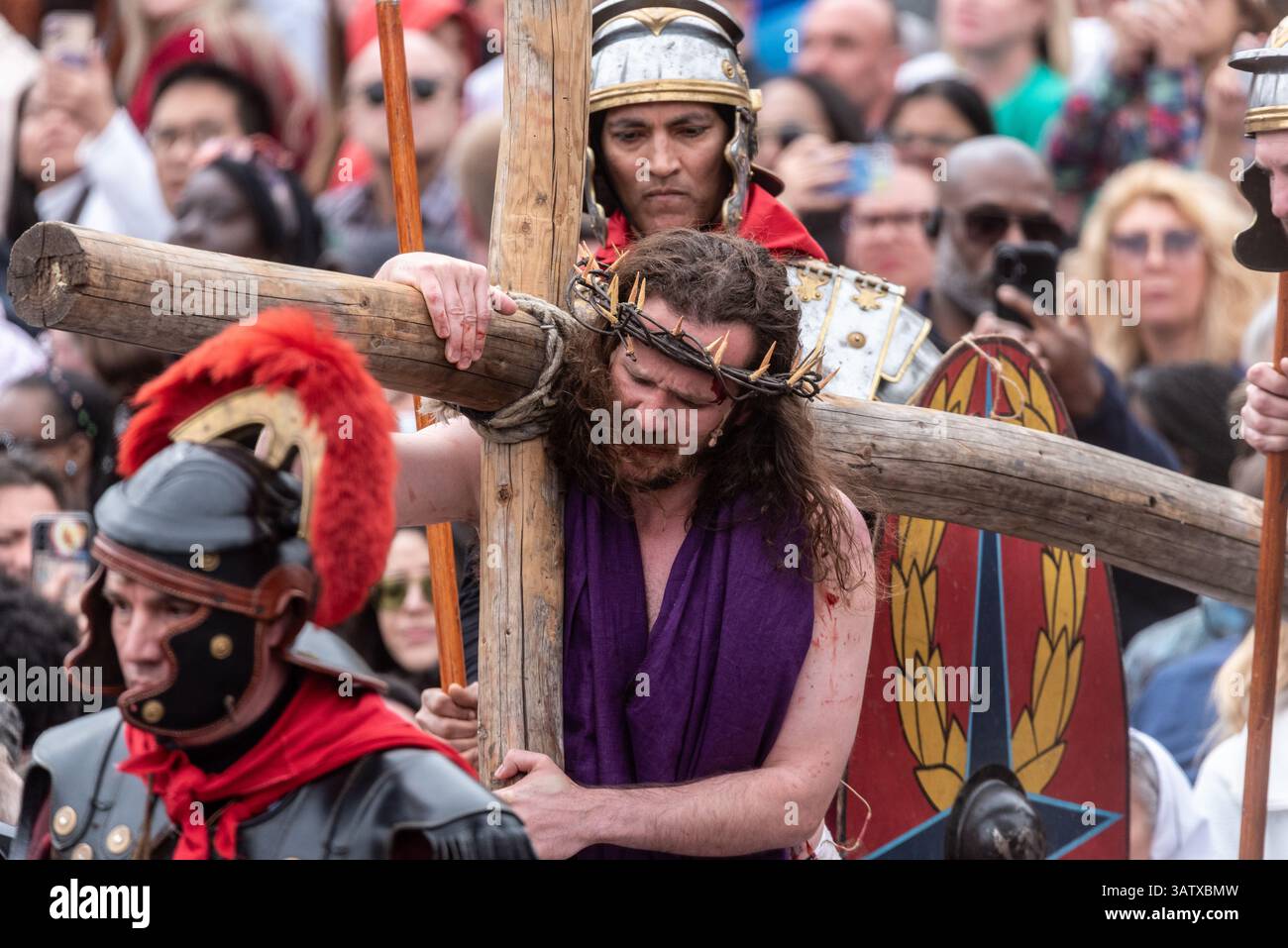 Jesus Christ, played by Peter Bergin, carrying the Crucifixion cross ...