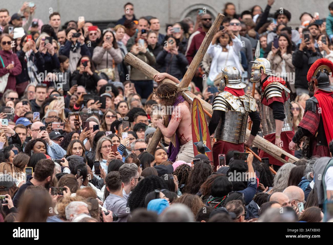 Jesus Christ, played by Peter Bergin, carrying the Crucifixion cross ...
