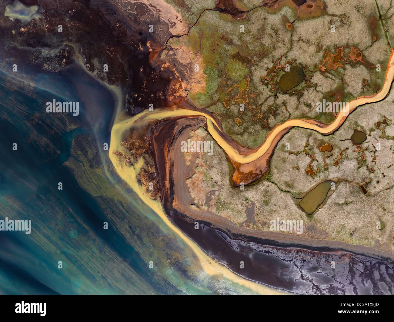Aerial view of a colorful river delta meeting the sea, with rich earthy ...