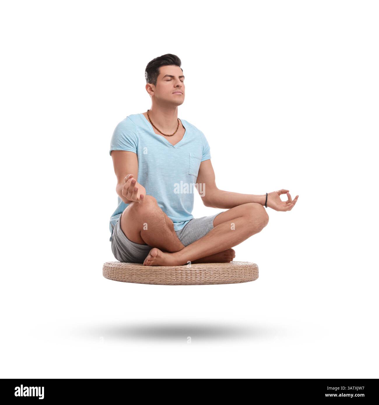 Man levitating during meditation on white background. Practicing yoga ...