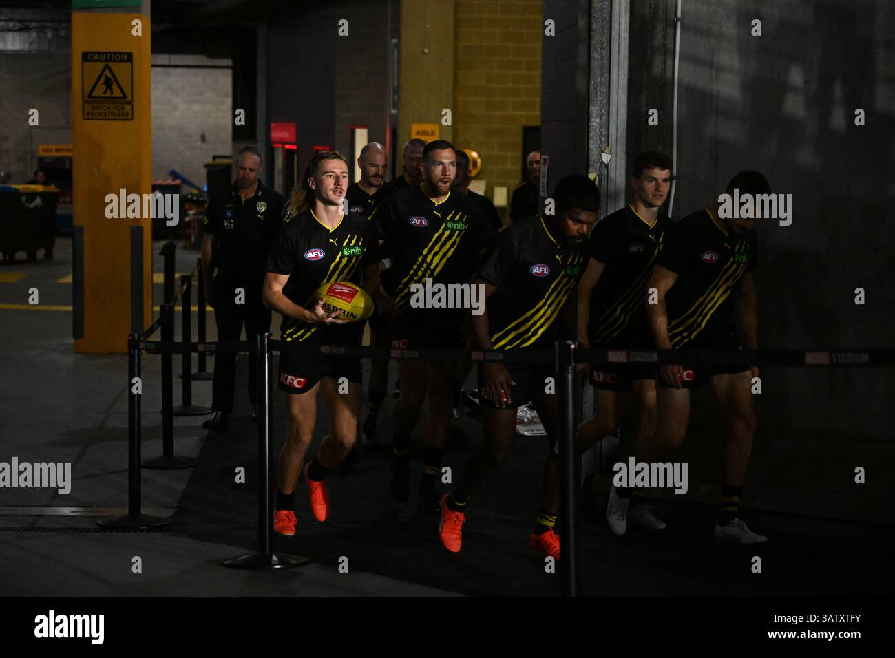 Noah Balta of Richmond (centre) runs up the race to warm up ahead of ...