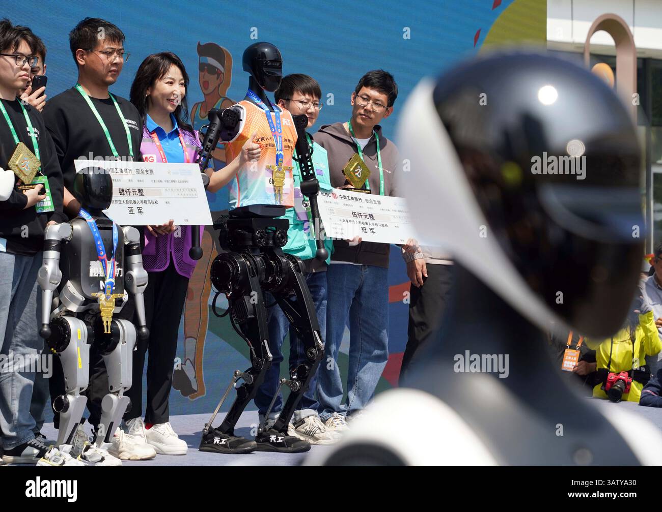 The photo shows a robot winning a medal at the robot half marathon in ...