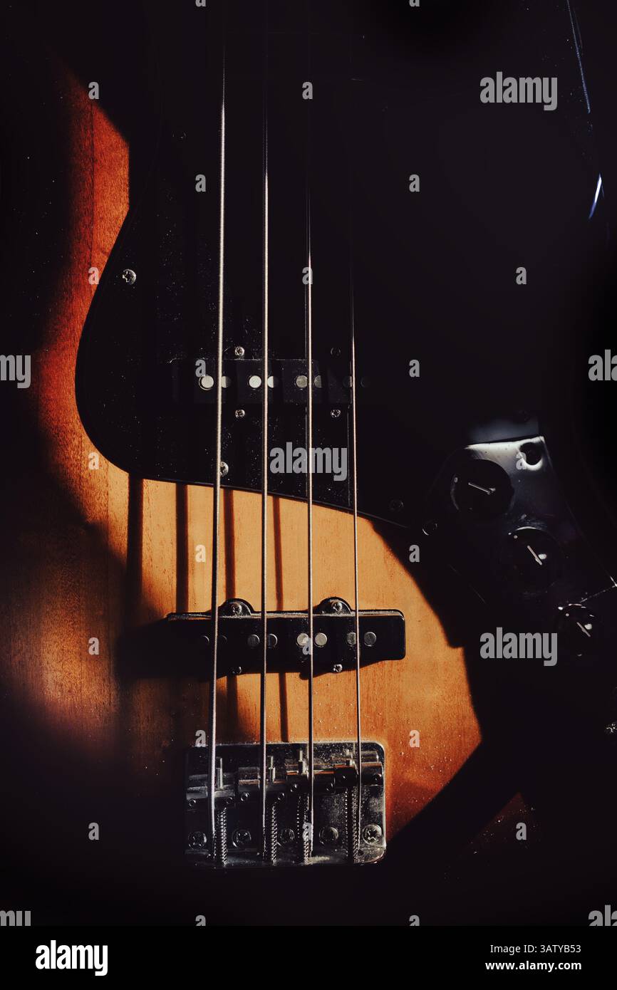 Interesting lighting of a four-string bass guitar Stock Photo - Alamy