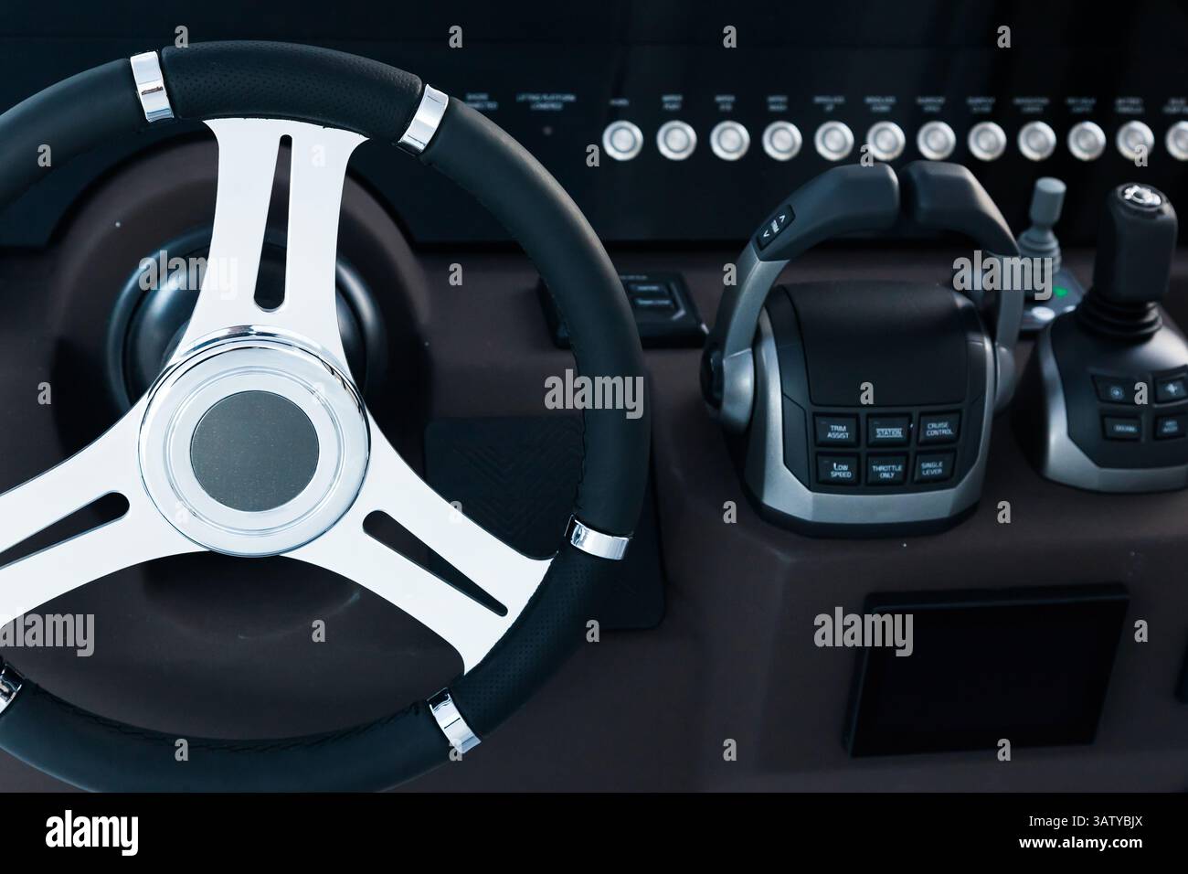 Motor yacht control panel. Steering wheel, gear levers, control buttons ...