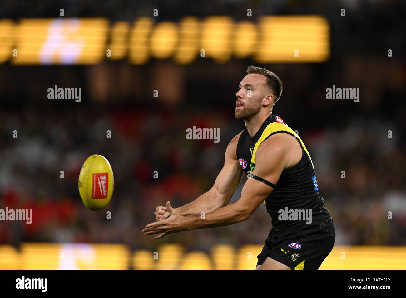 Noah Balta of Richmond handballs the footy during the AFL Round 6 match ...