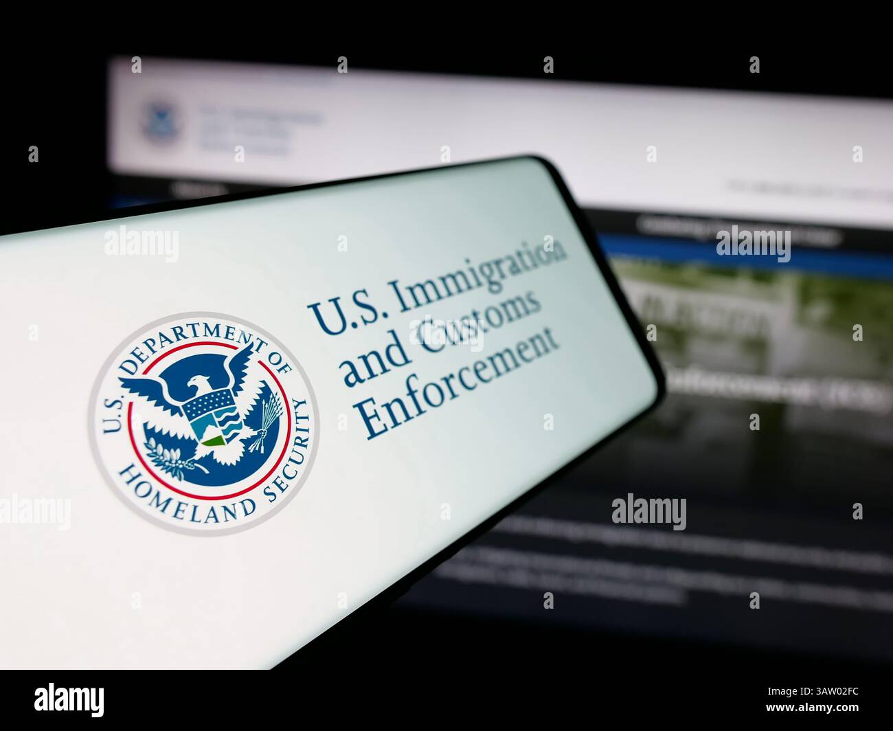 In this photo illustration, a smartphone with the logo of US Immigration and Customs Enforcement ...