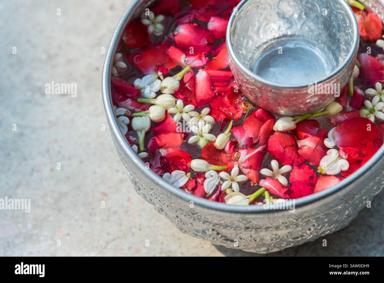 Songkran Festival with cool fresh water have a jasmine flower and rose ...