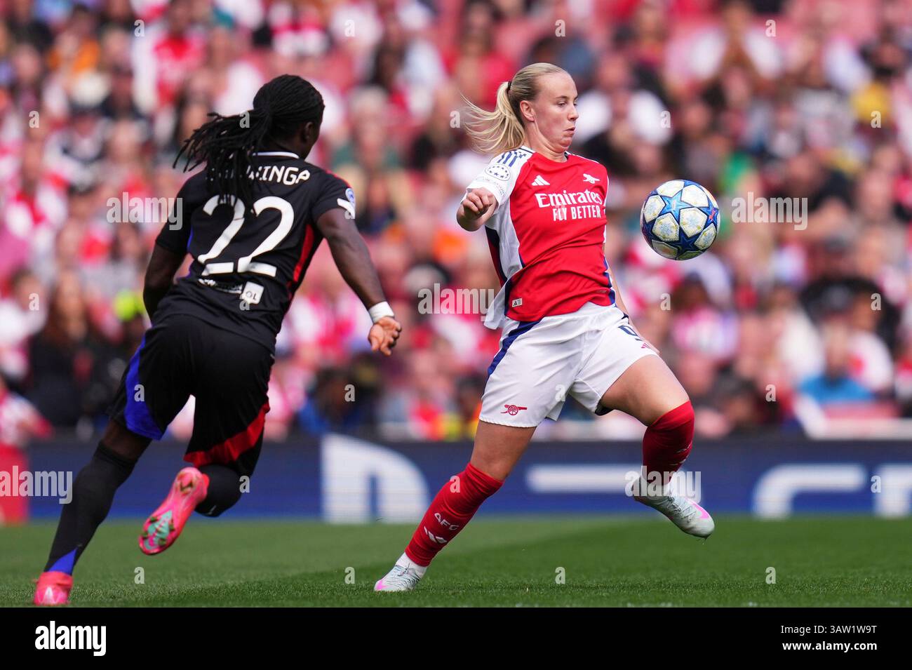 Arsenal's Beth Mead controls the ball next to Lyon's Tabitha Chawinga ...