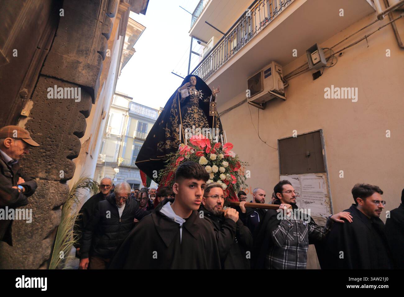 Faithful seen in procession through the historic center on Friday of ...