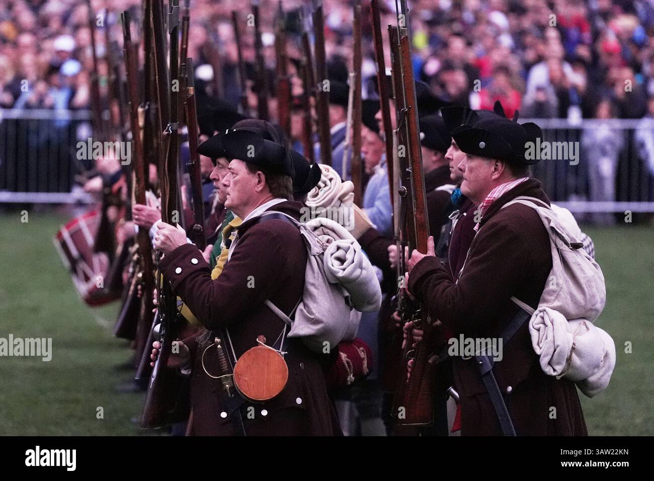 New England colonial militia, also known as a Minuteman, stand in line ...