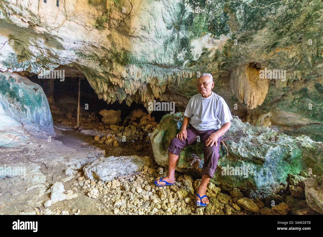 An elderly male shaman poses inside a cave in Bohol, Philippines during ...
