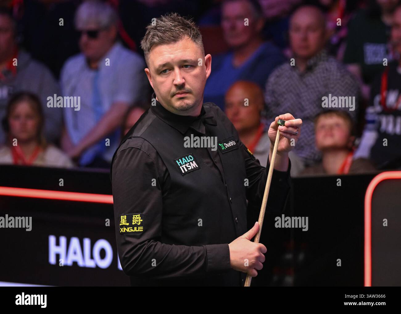 Sheffield, England, 19th April 2025. Kyren Wilson chalks his cue during ...