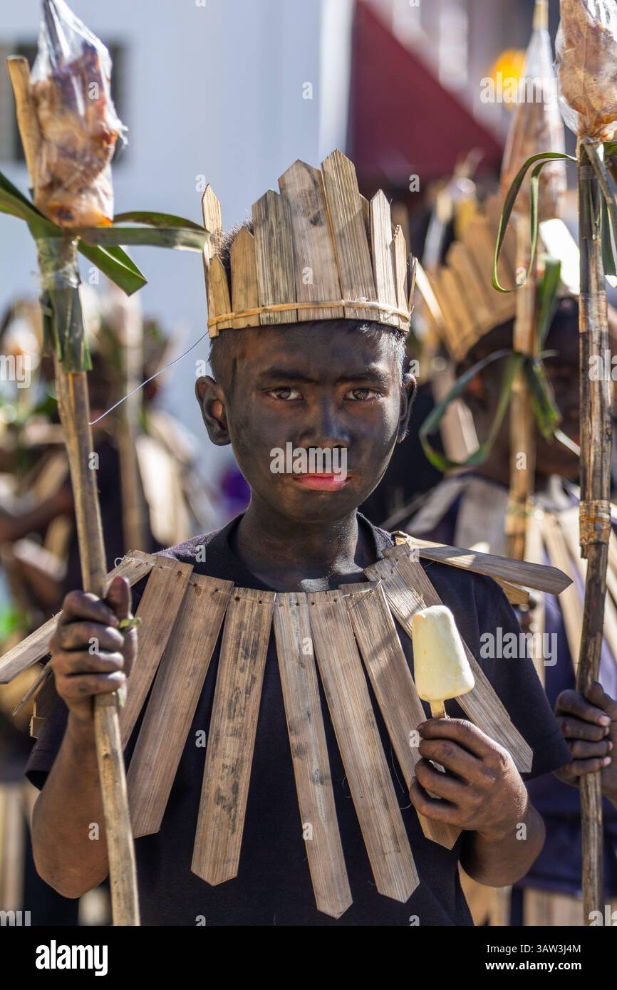 Participant in black face paint to honor the Ati tribe and wearing ...