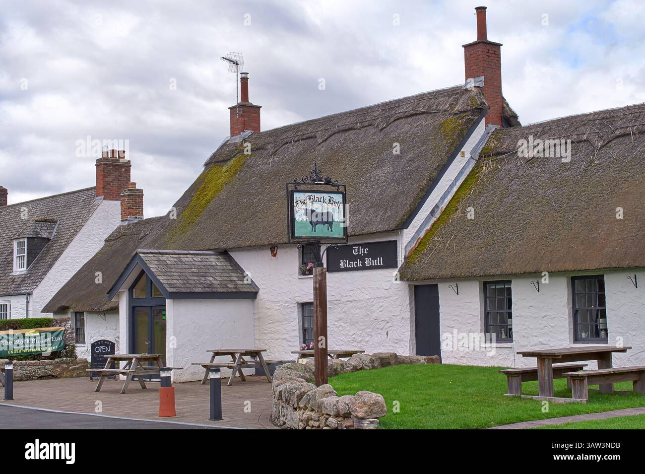 The Black Bull Pub with thatched roof, Etal, Northumberland, England ...