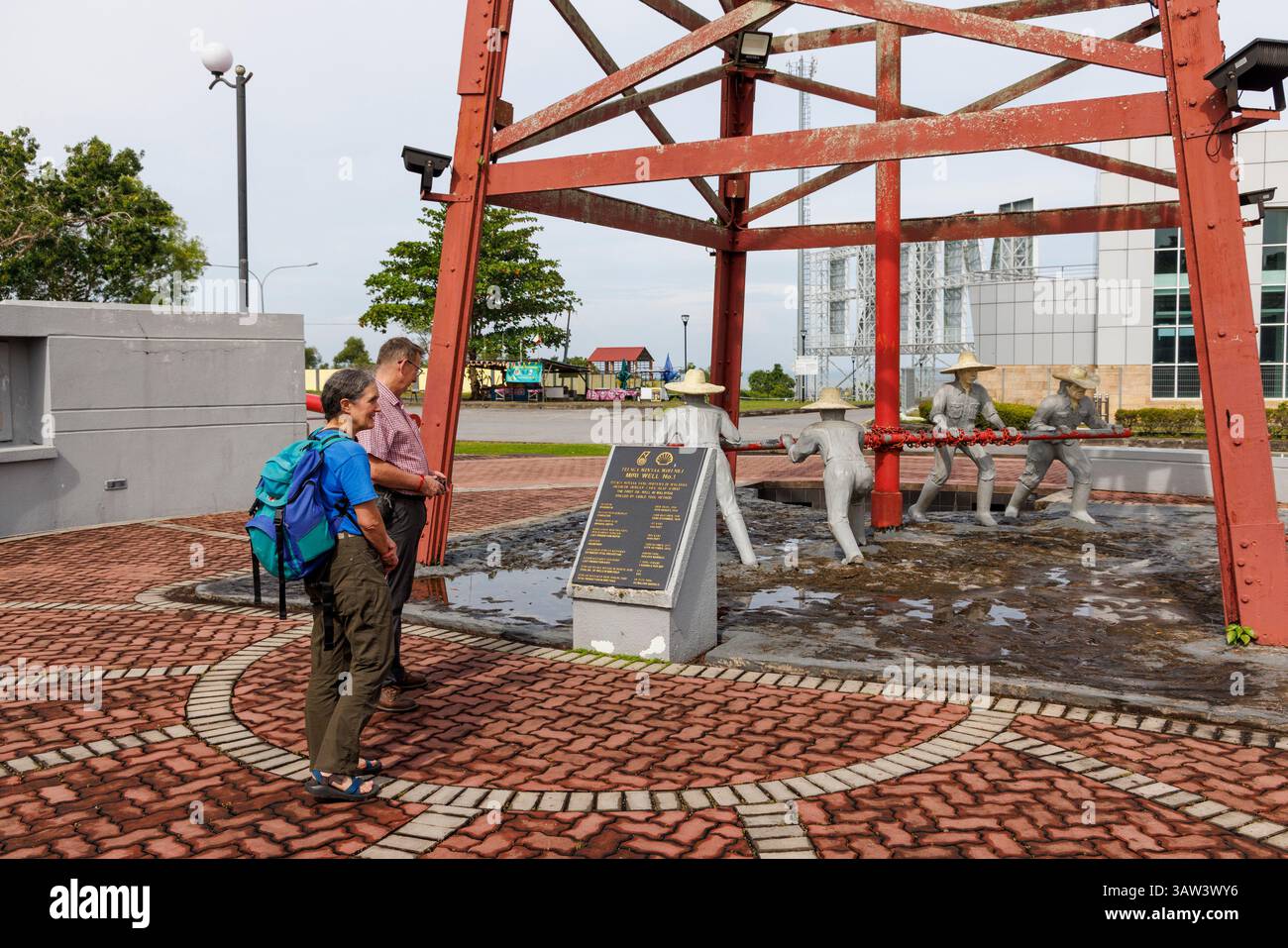 People reading the information sign about the first oil drilling rig in ...