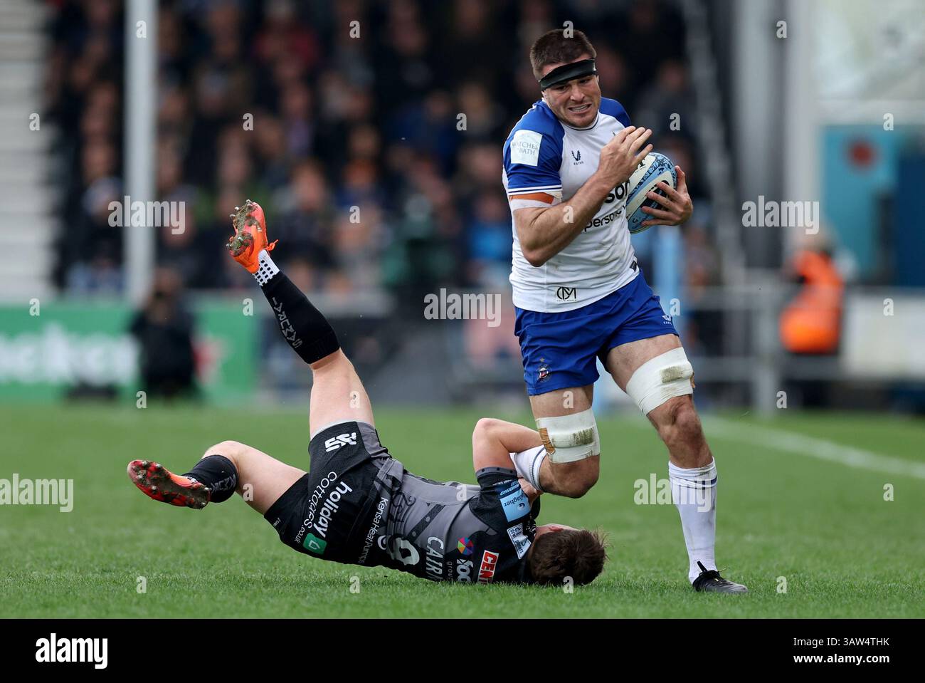 Bath's Josh Bayliss (right) is tackled by Exeter Chiefs' Tom Cairns ...