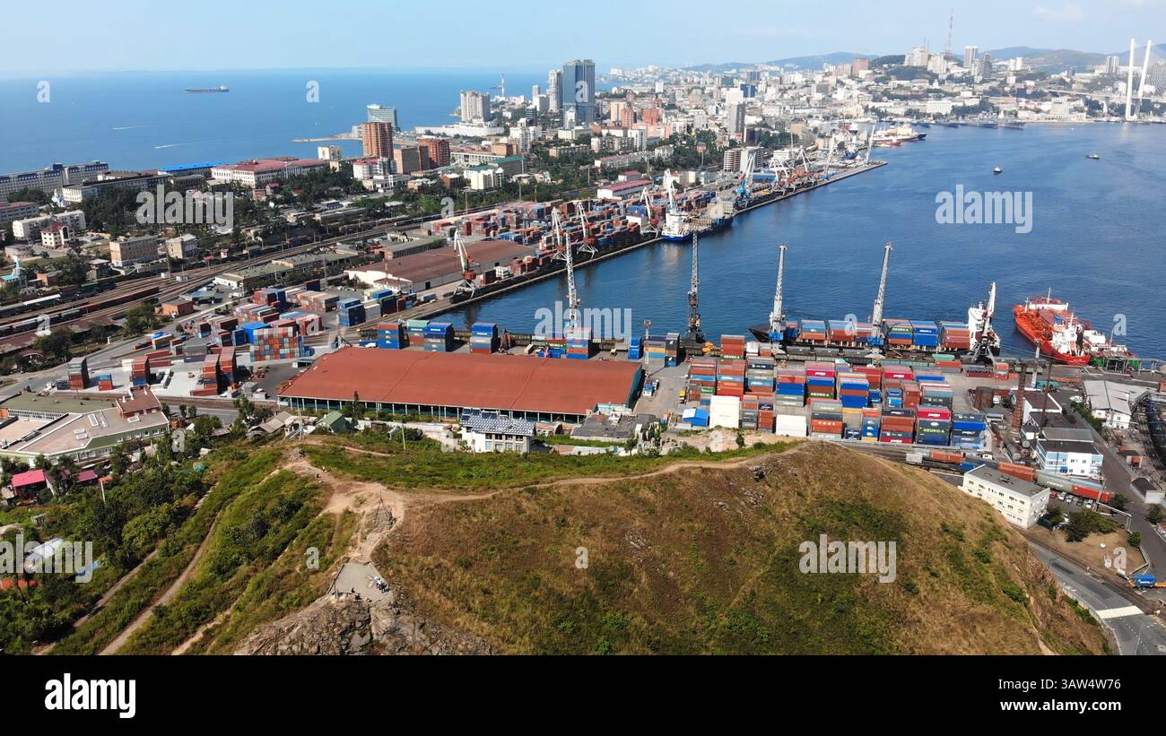 Cargo ships are docking and unloading at the commercial sea port in ...