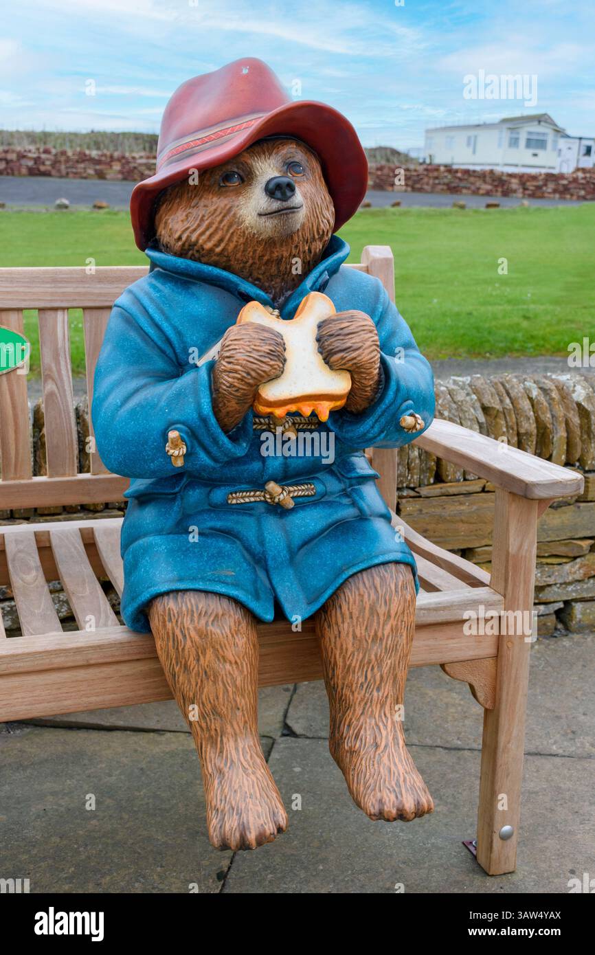 Statue of Paddington Bear sitting on a bench eating a marmalade sandwich. John o'Groats ...