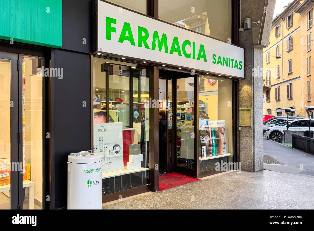 Milan, Italy - April, 07, 2025: Street-level view of Farmacia Sanitas ...