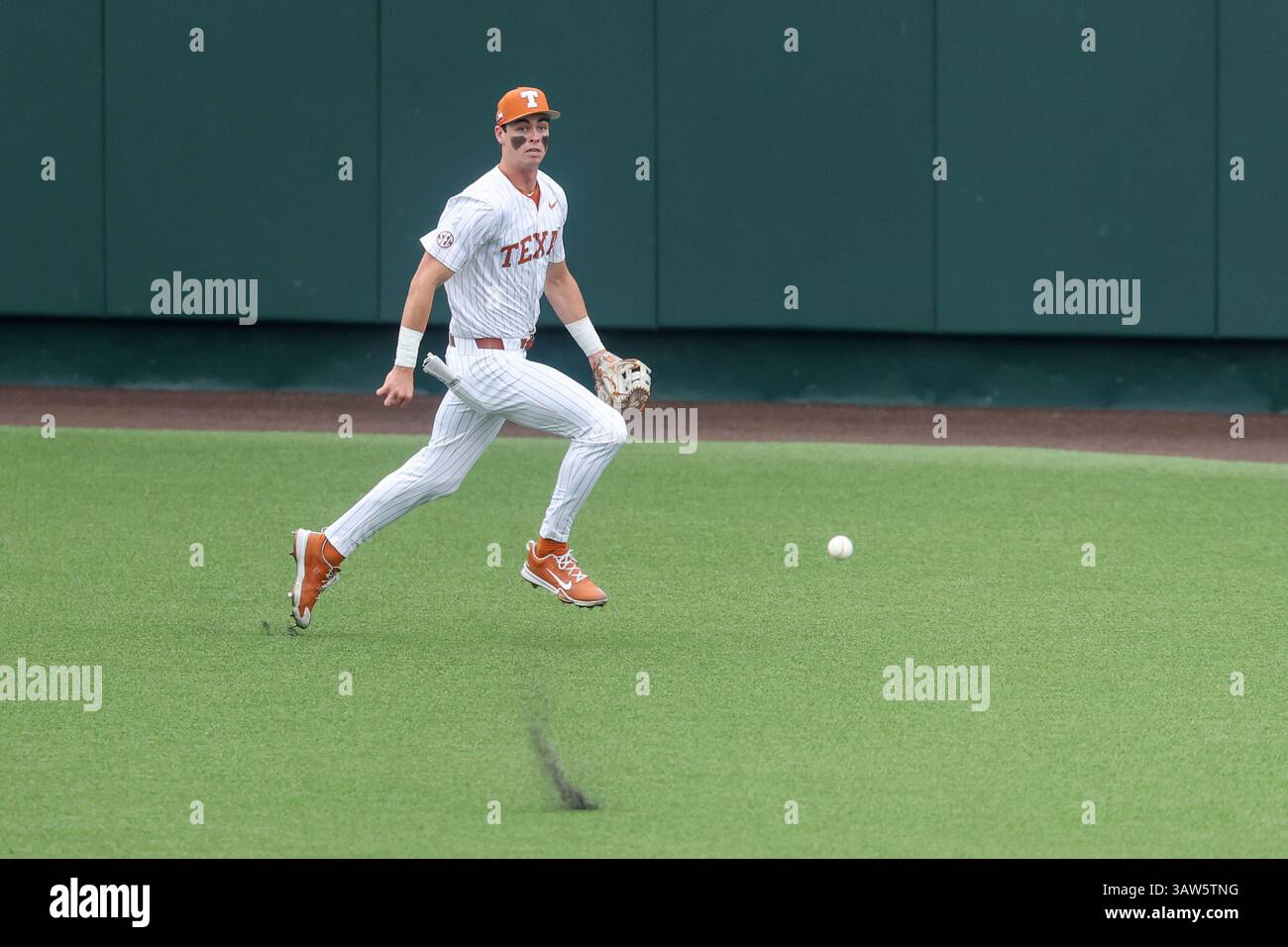 AUSTIN, TX - APRIL 18: Texas outfielder Will Gasparino (8) runs down a ...