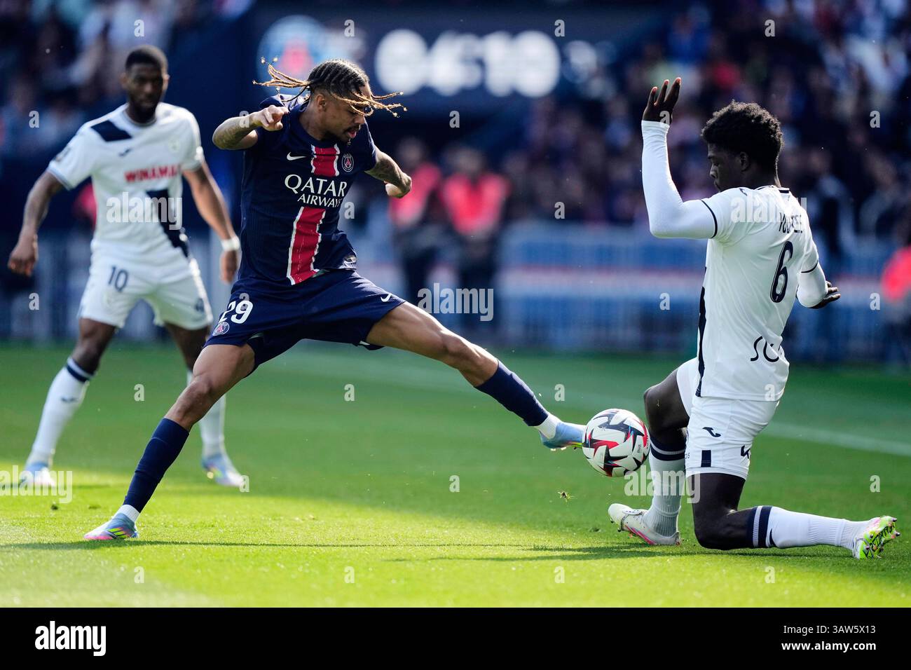PSG's Bradley Barcola, left, challenges for the ball with Le Havre's ...