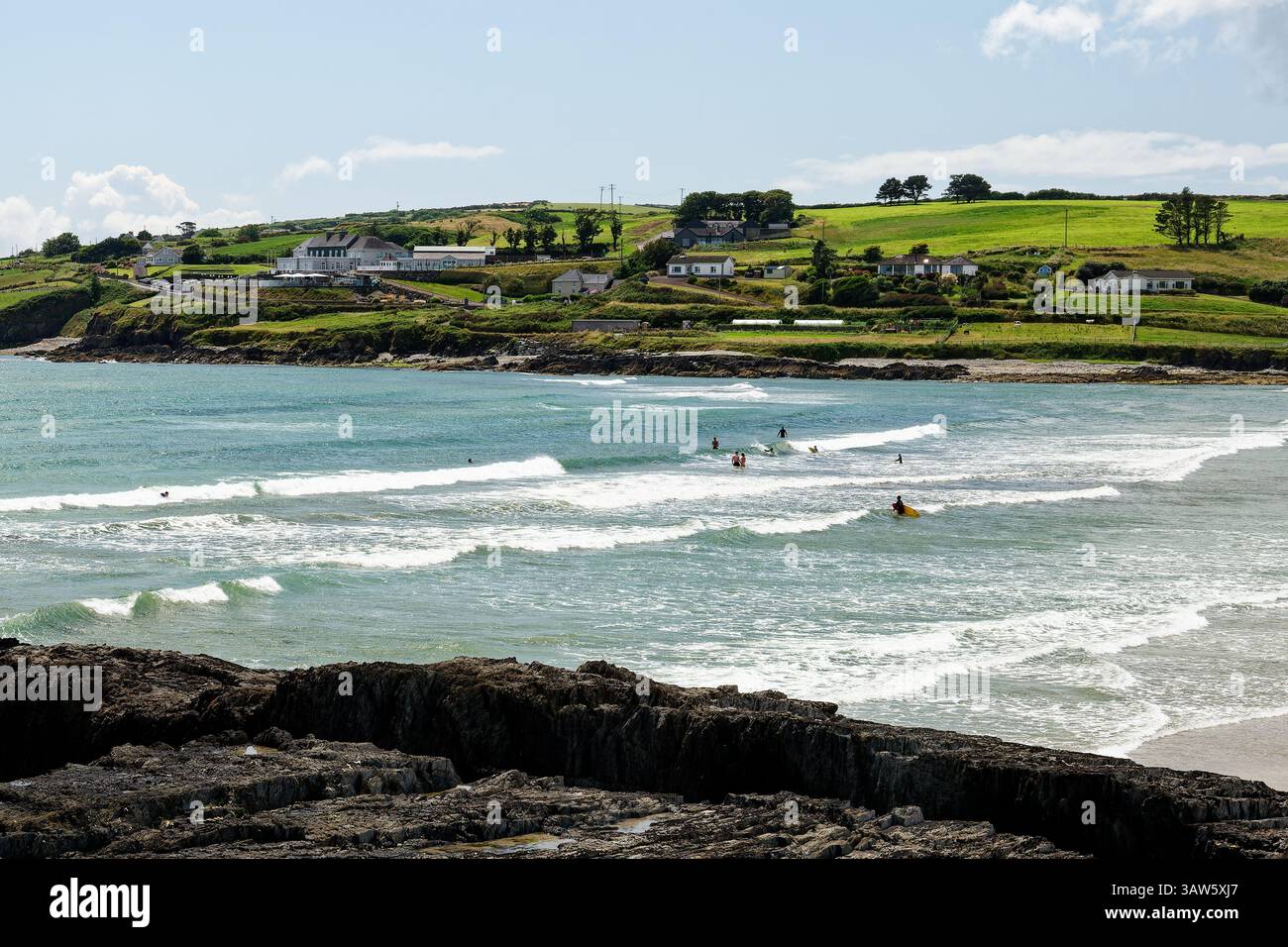 West Cork, June 25, 2023. On a bright day at Inchydoney Beach, surfers ...